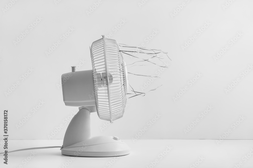 White desktop electric fan. Escape from the hot summer heat. Cooling of ...