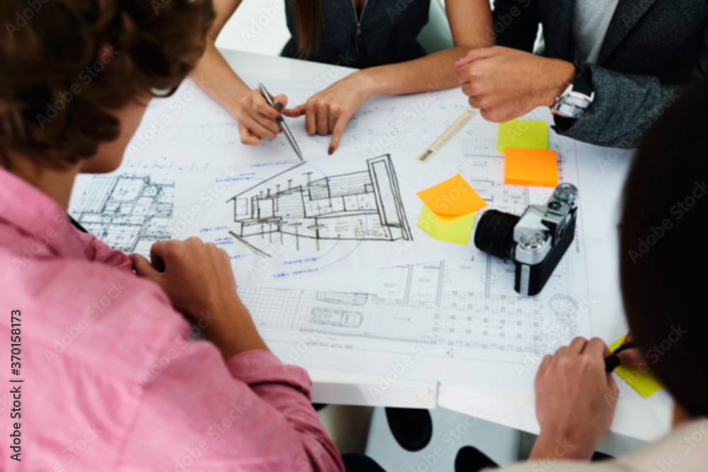 Cropped image of male and female hands drawing plan for modern ...