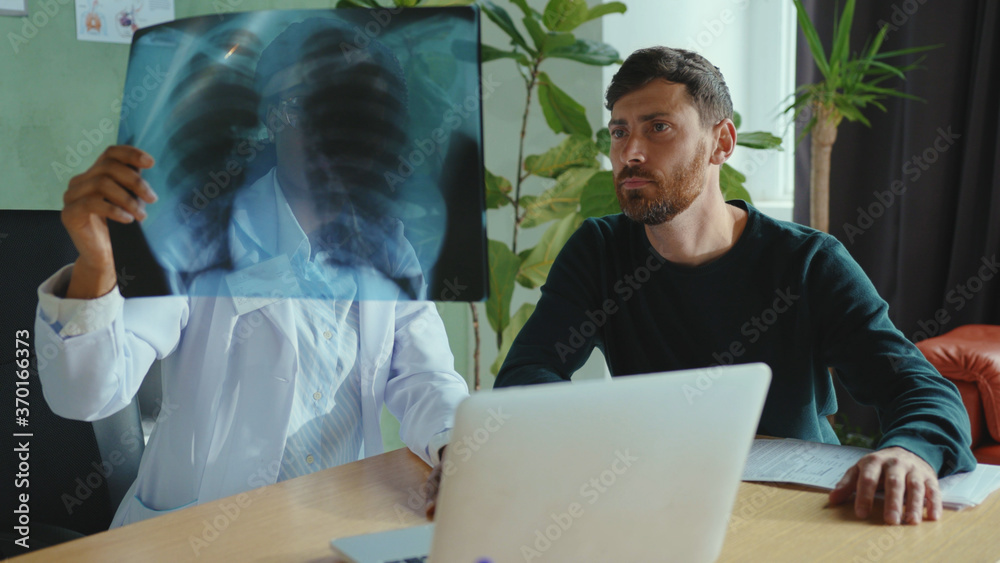 Beautiful black female doctor analyzing fluorography test of her ...