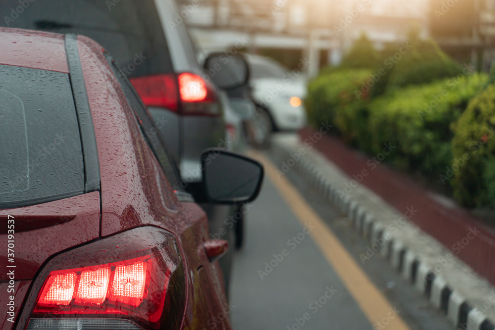 Back of a red car that was wet in rain, waited in line and caught a ...