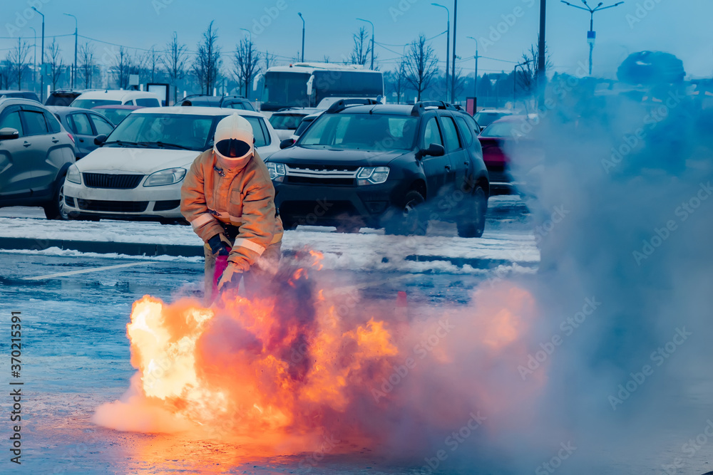 Fire fighting in the Parking lot. Firefighter eliminates ignition ...