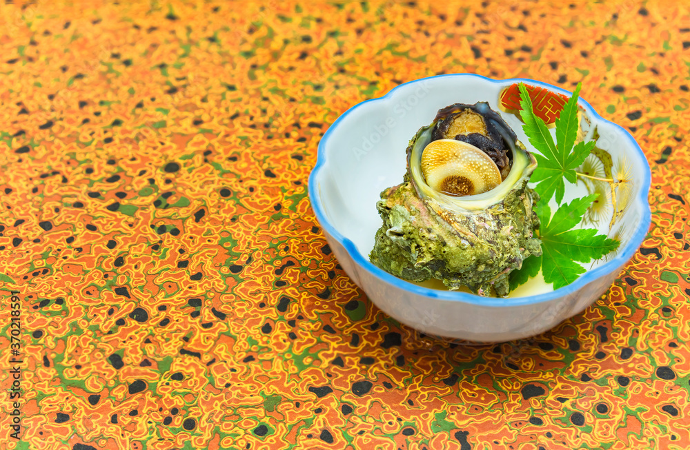 High-class japanese cuisine of traditional Tsubo-yaki steamed Sazae ...