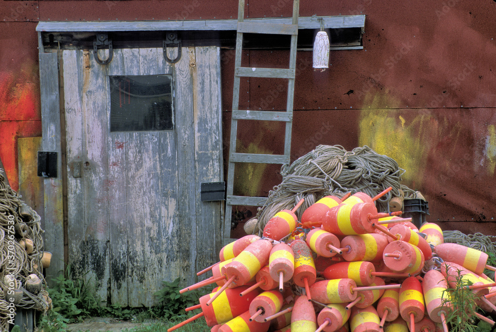 Very weathered fishing shack with old wooden ladder, colorful stack of ...