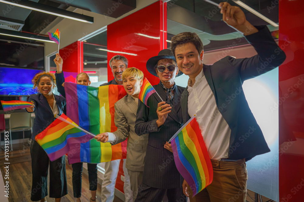 diverse group of lgbtq people with rainbow flag on hand team up ...