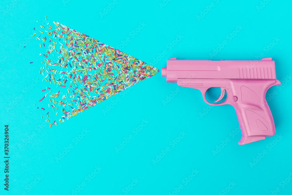 Pink gun with decorative candies instead of bullets. Pink gun toy ...
