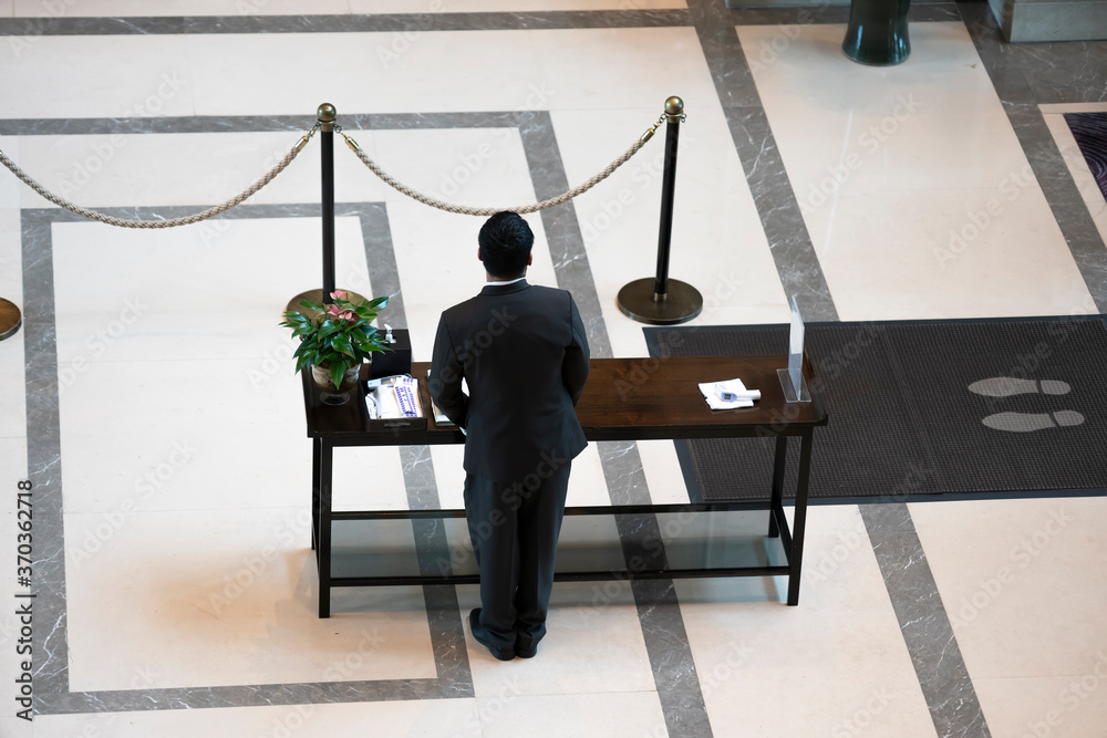 Hotel staff Fever screening service At the entrance to the building To ...