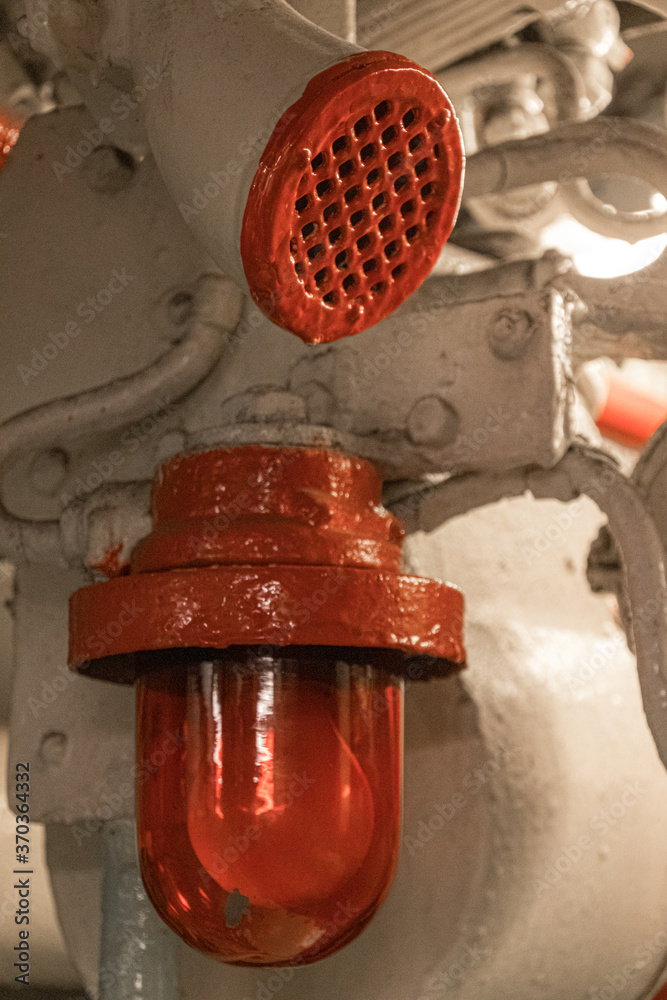 Red alarm light and speaking tube onboard a historical submarine made ...