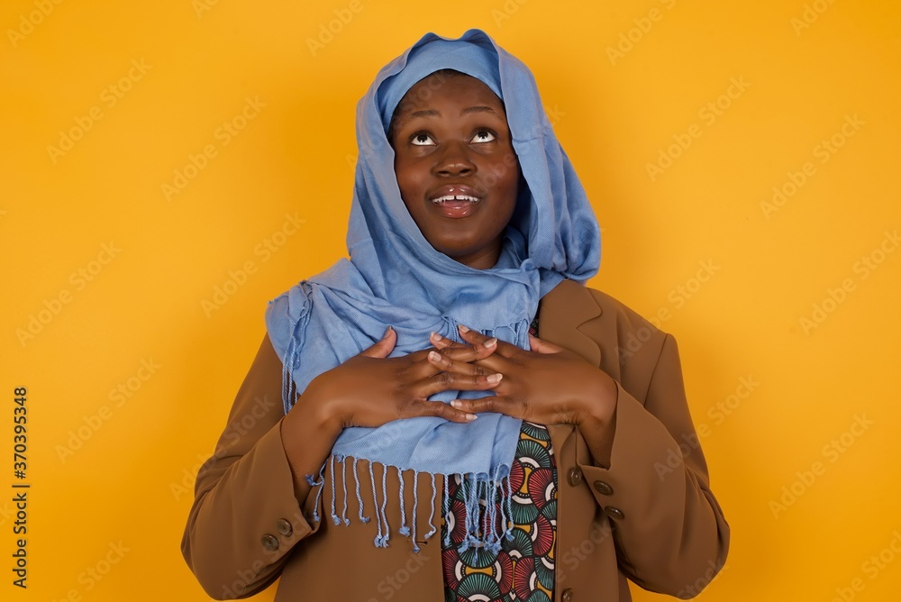 Happy business woman standing and smiling isolated on gray studio ...