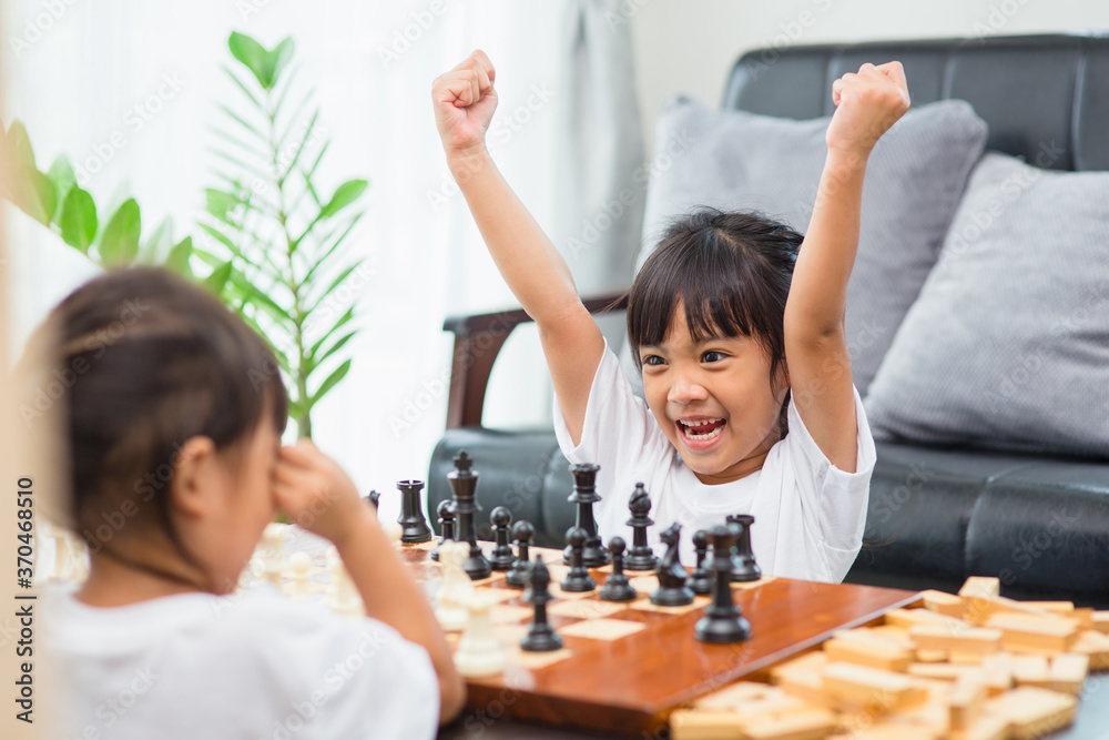 Kids playing chess - one of them just captured a pawn and celebrates ...