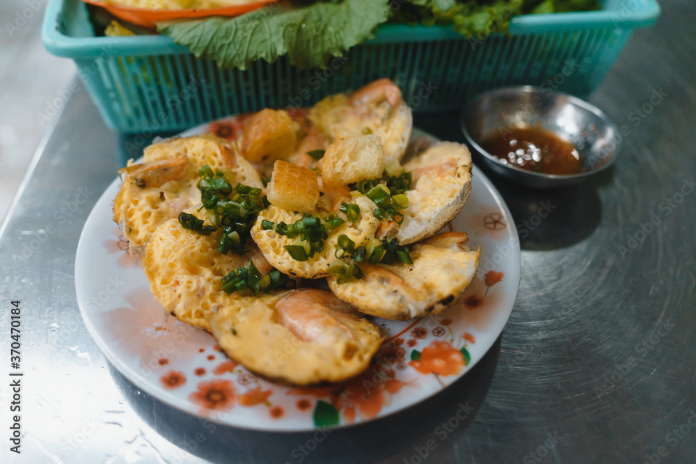 Vietnamese street food "banh can" make by rice powder with rice flour ...