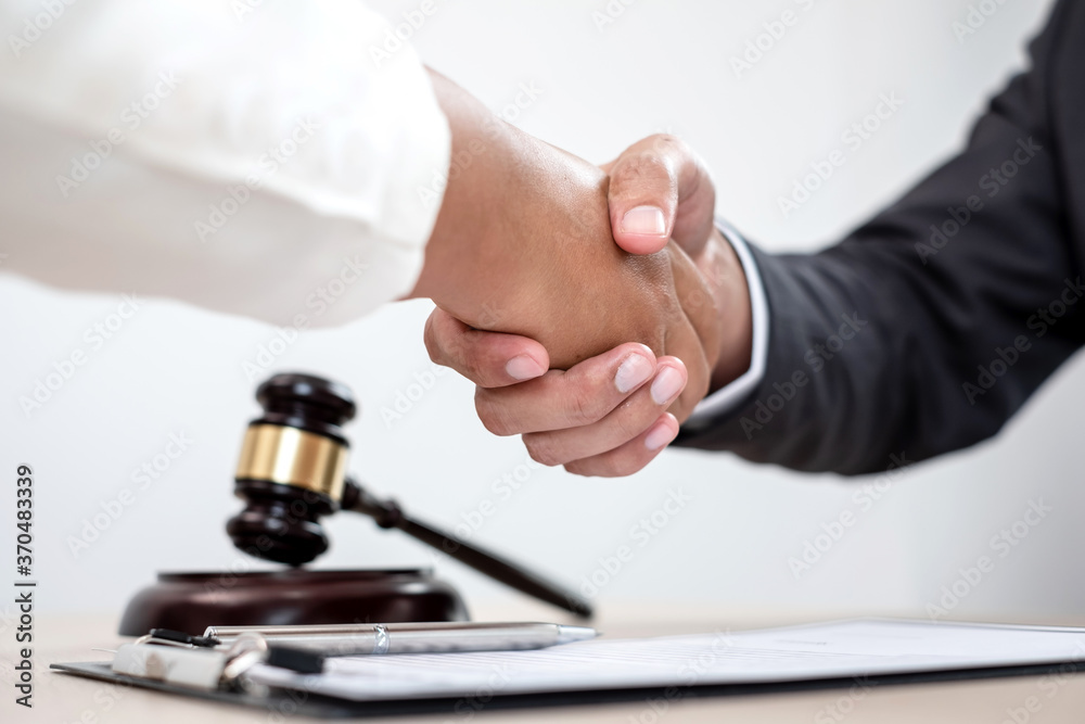 shake hand Professional male lawyers work at a law office There are ...