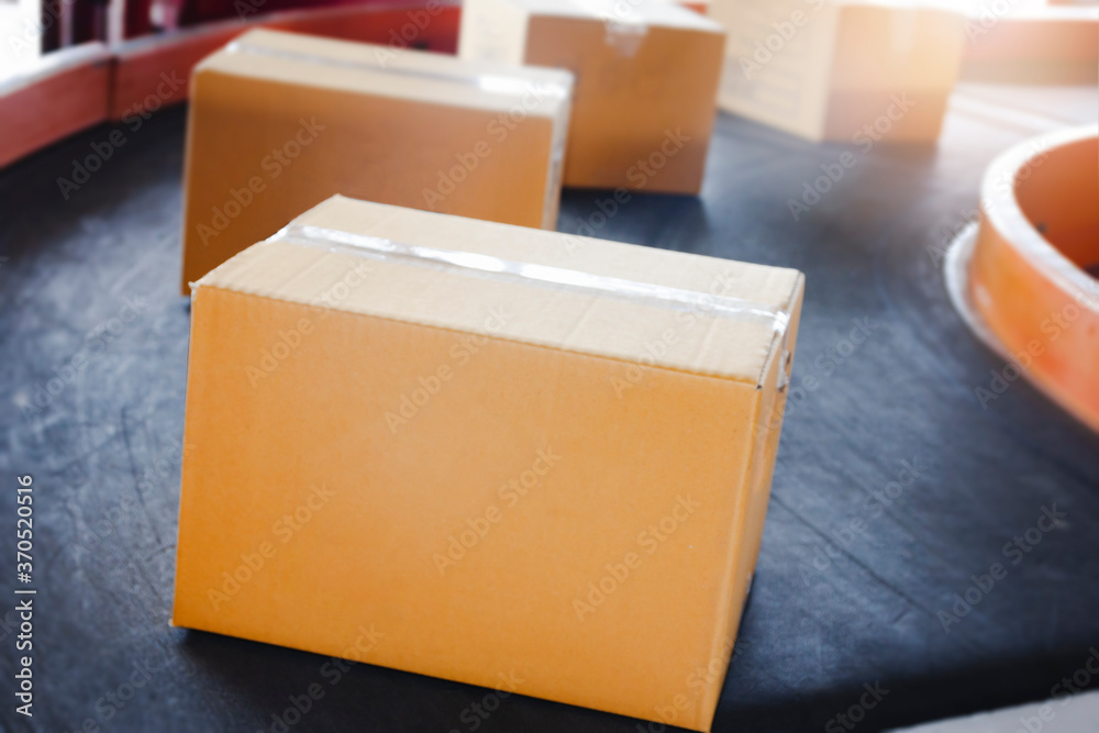 Cardboard boxes sorting on conveyor belt in distribution warehouse ...