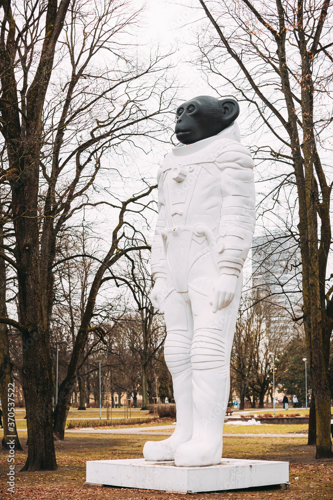 Riga, Latvia. Monkey statue in a spacesuit in Kronvalda park. Statue is ...