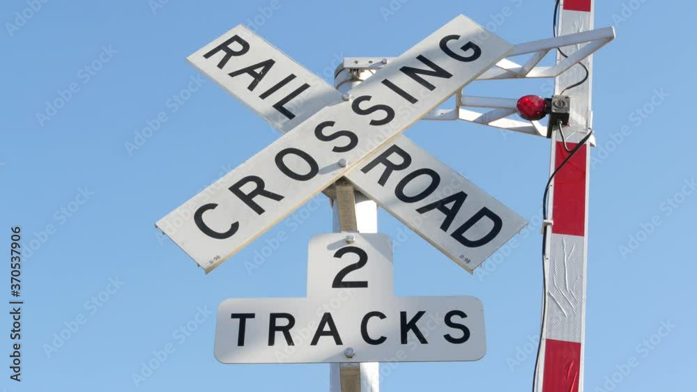 Level crossing warning signal in USA. Crossbuck notice and red traffic ...