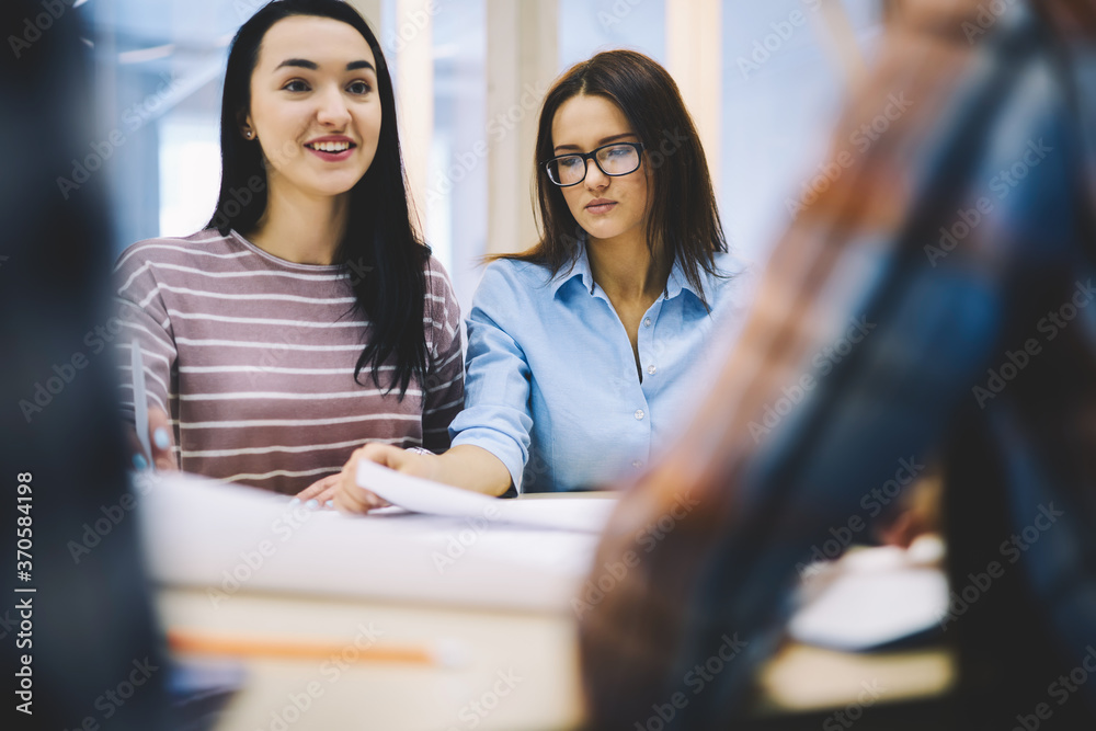 Young female colleagues planning improvement strategy for working ...