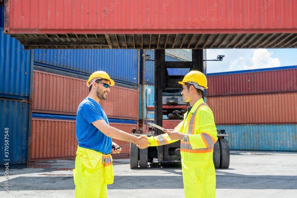 Container worker working together at cargo freight logistic warehouse ...