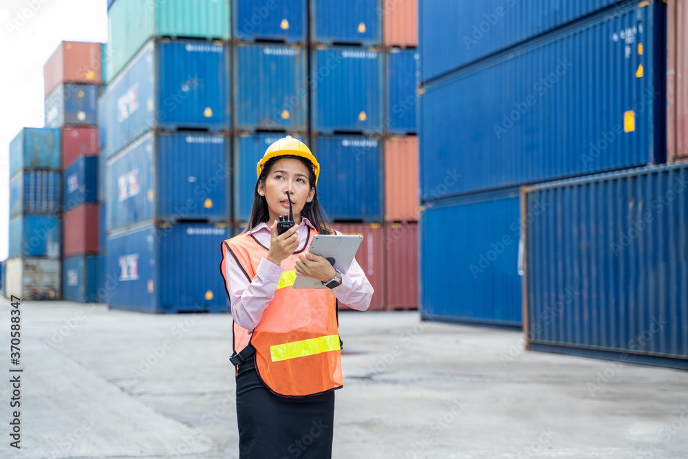 Contenner woman worker with laptop checking position loading containers ...