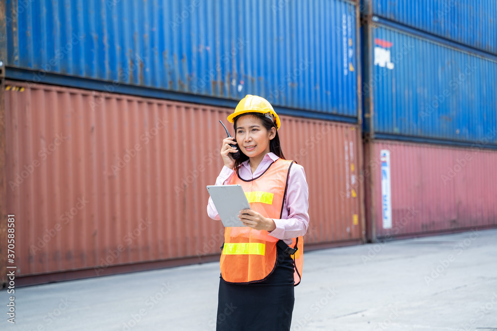 Contenner woman worker with laptop checking position loading containers ...