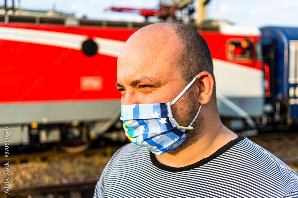 Young man with medical protective face mask illustrates pandemic ...