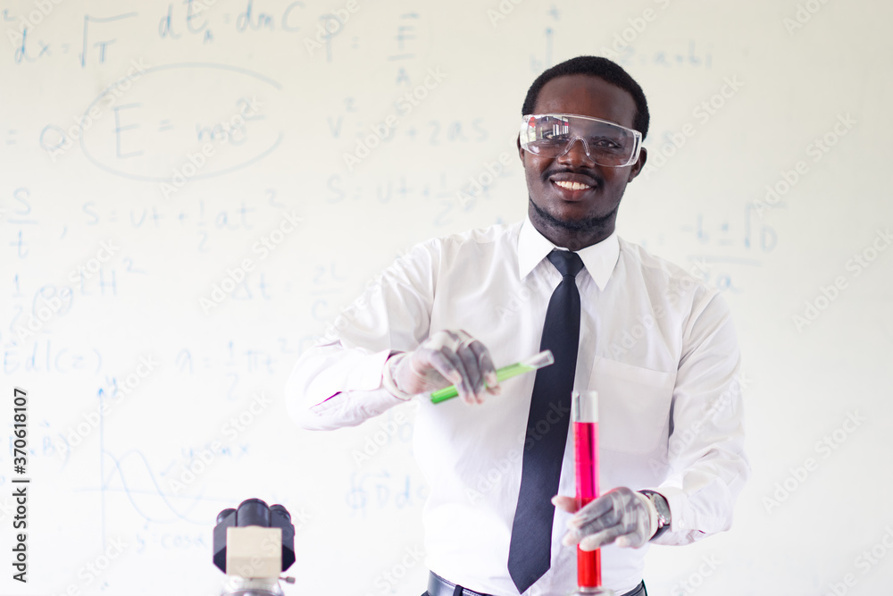 Science african teacher standing in front of blackboard teaching ...