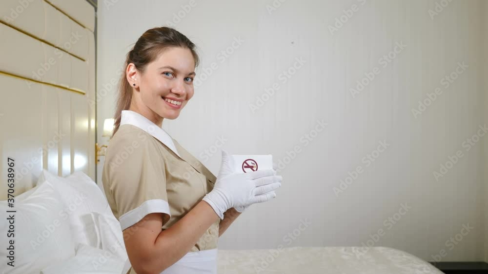 No smoking allowed sign in pretty maid gloved hands. Portrait of ...