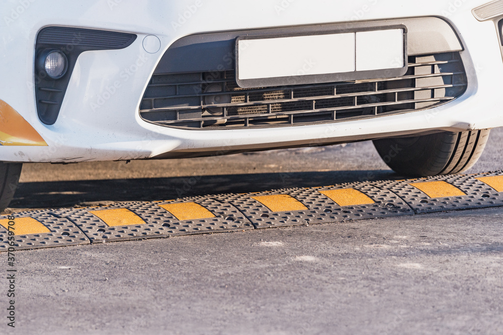 Traffic safety speed bump on the asphalt road. Stock Photo | Adobe Stock