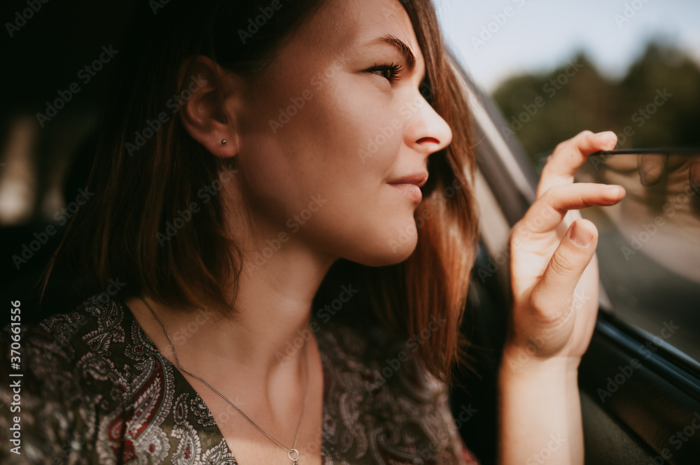 beautiful young woman with dark short hair and silver earrings looks ...