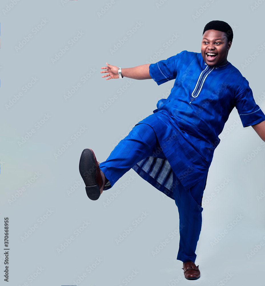 young excited man jumping wearing African native attire Stock Photo ...