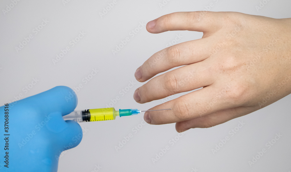 Orthopedic surgeon gives an injection in the finger joint. Treatment of ...