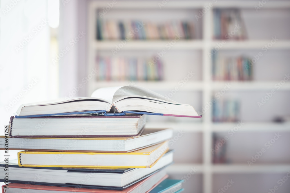 Book stack on the table in the library room and blurred space of ...