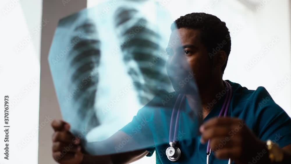 Vidéo Stock Close-up of young African American man doctor wearing blue ...