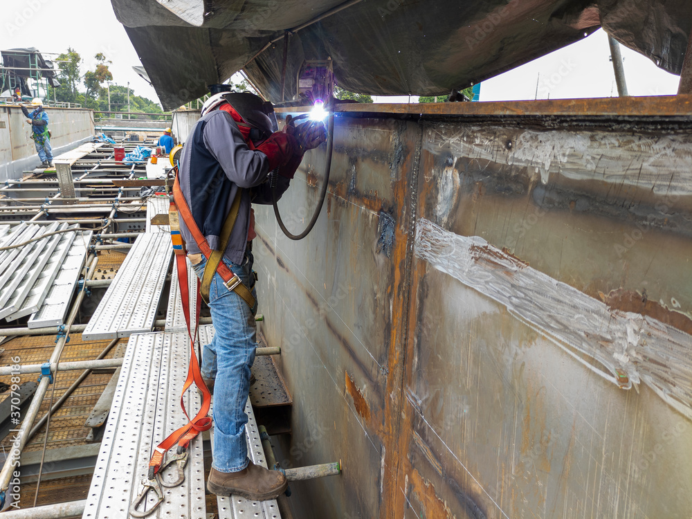 Foto de The welder is welding a steel structure work with process Flux ...