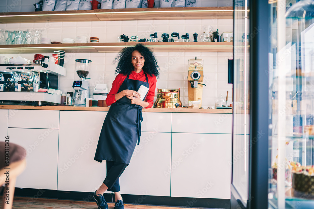 Full length portrait of positive african american employee of cafe ...
