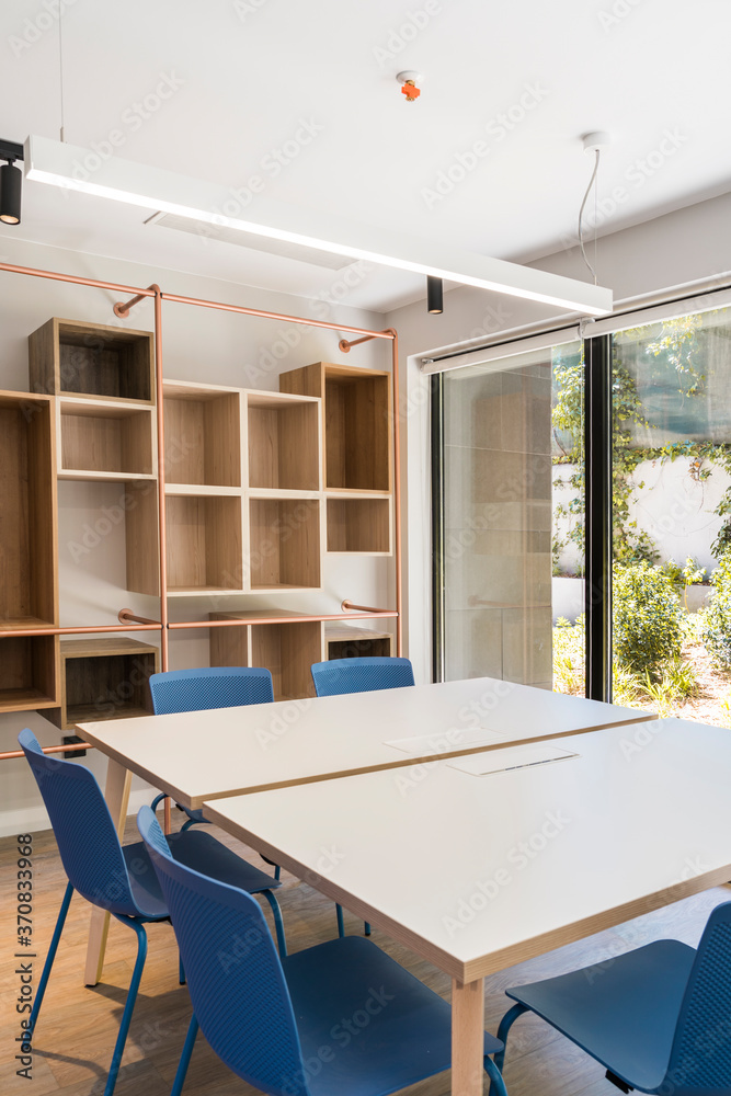 Modern style office interior with square tables and blue stools on ...