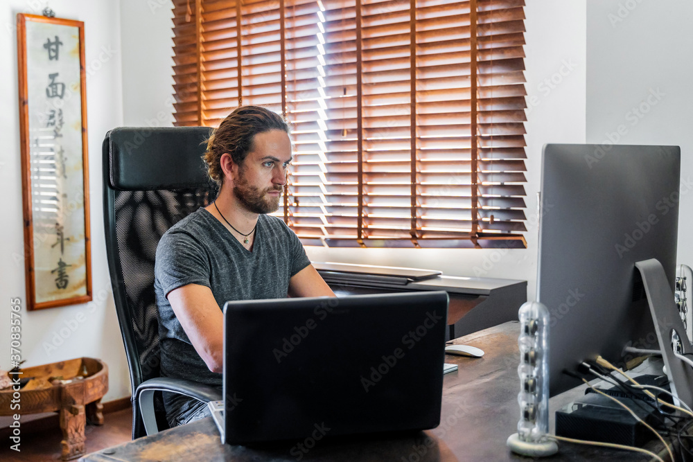 Handsome man working at desktop computer at home Stock Photo | Adobe Stock