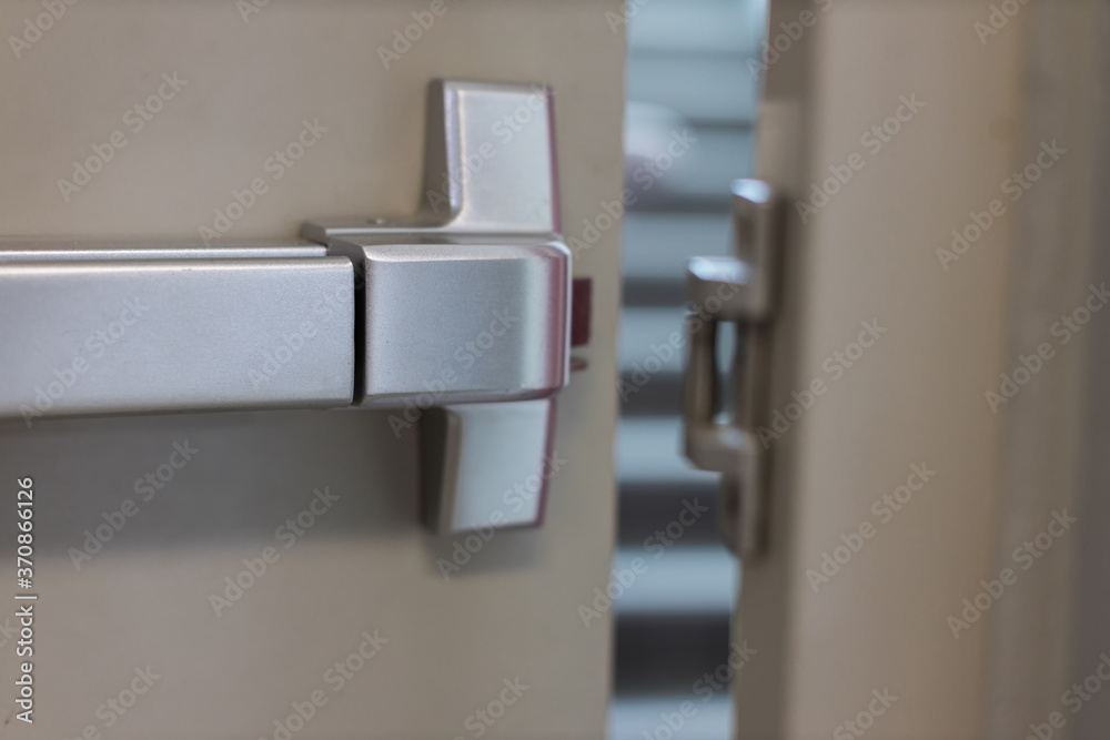 Emergency fire exit door. Closed up latch and rusty door handle of ...