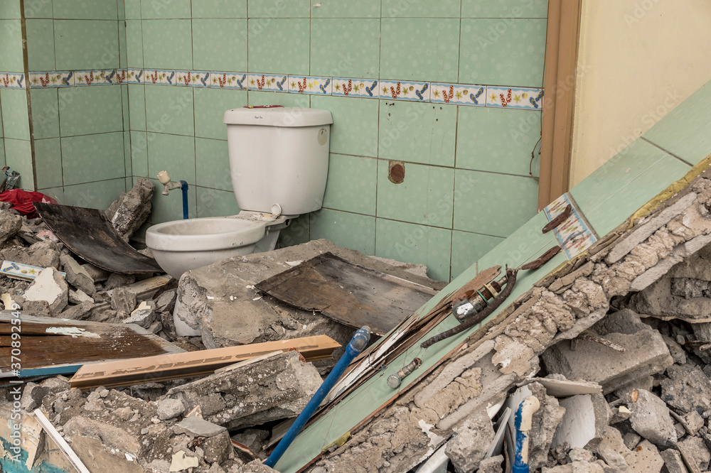 A demolished bathroom, with one wall and the toilet still intact. Can ...