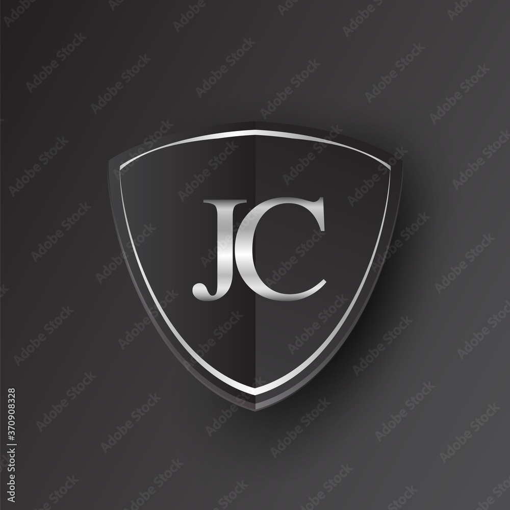 Initial logo letter JC with shield Icon silver color isolated on black ...
