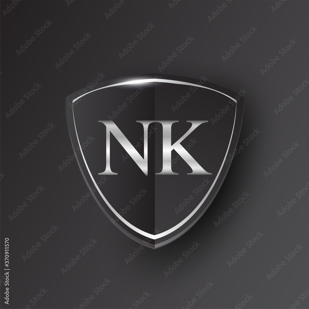 Initial logo letter NK with shield Icon silver color isolated on black ...