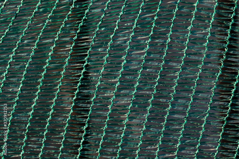 Green synthetic mesh texture. Construction fence made of plastic mesh ...