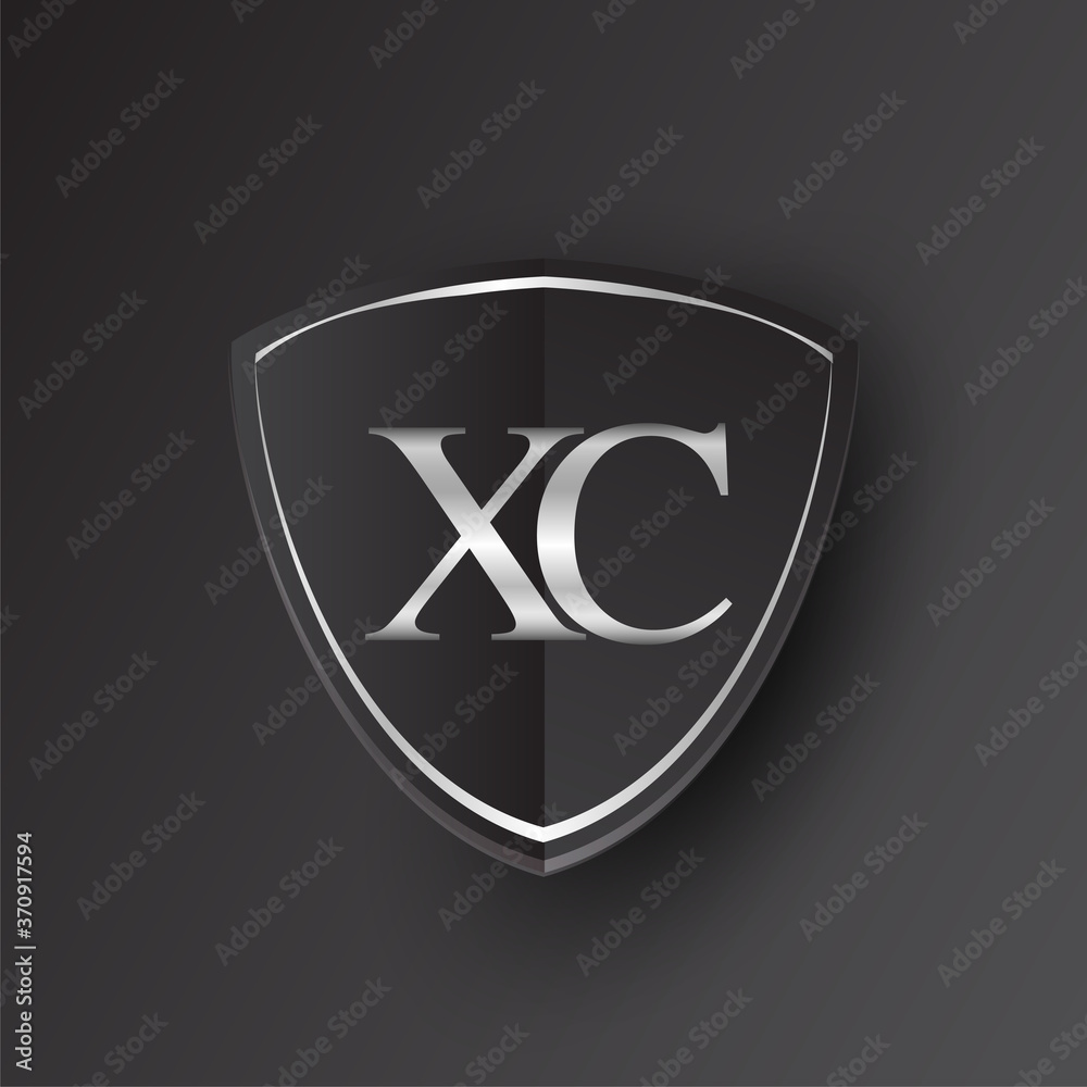 Initial logo letter XC with shield Icon silver color isolated on black ...