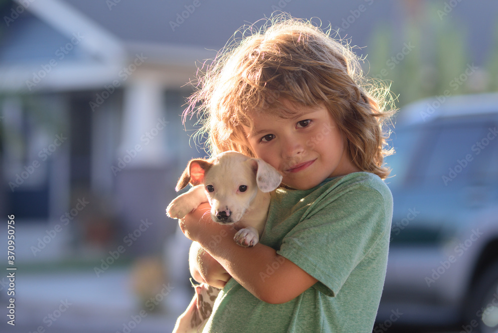 Little boy hugging a dog. Happy child and dog hugs her with tenderness ...