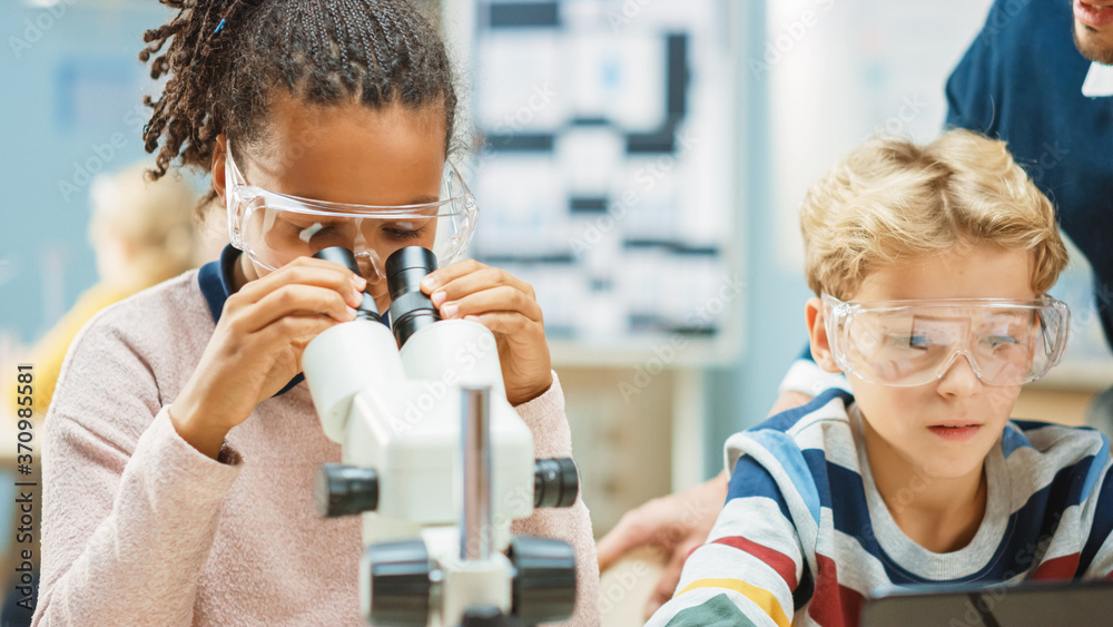 Elementary School Science Classroom: Cute Little Girl Looks Under ...