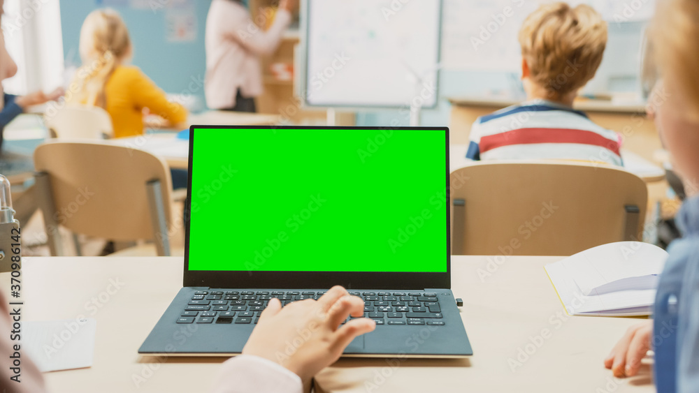 Elementary School Science Class: Little Girl Use Laptop with Green ...
