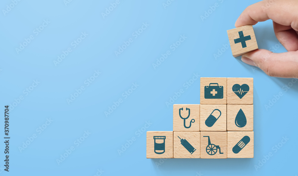 Hand arranging wood block stacking with icon healthcare medical ...