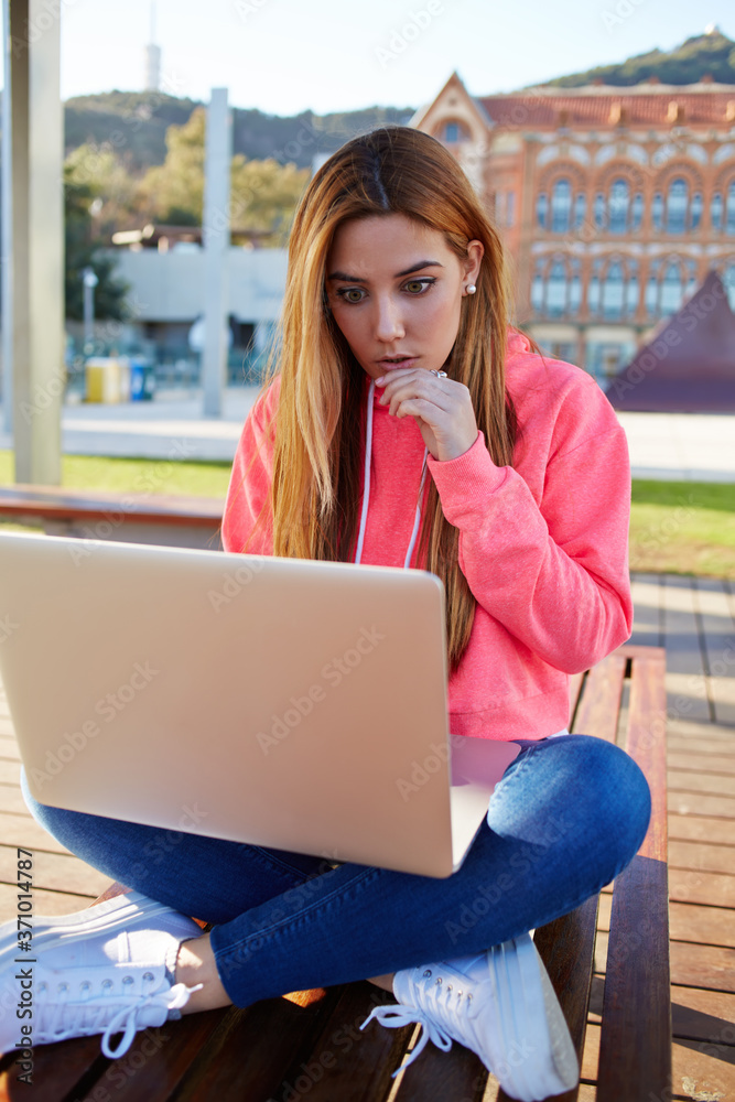 Gorgeous female student sitting with open laptop computer on campus ...