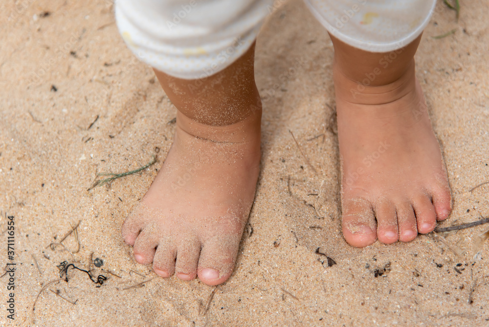 child's feet on the sand Stock Photo | Adobe Stock