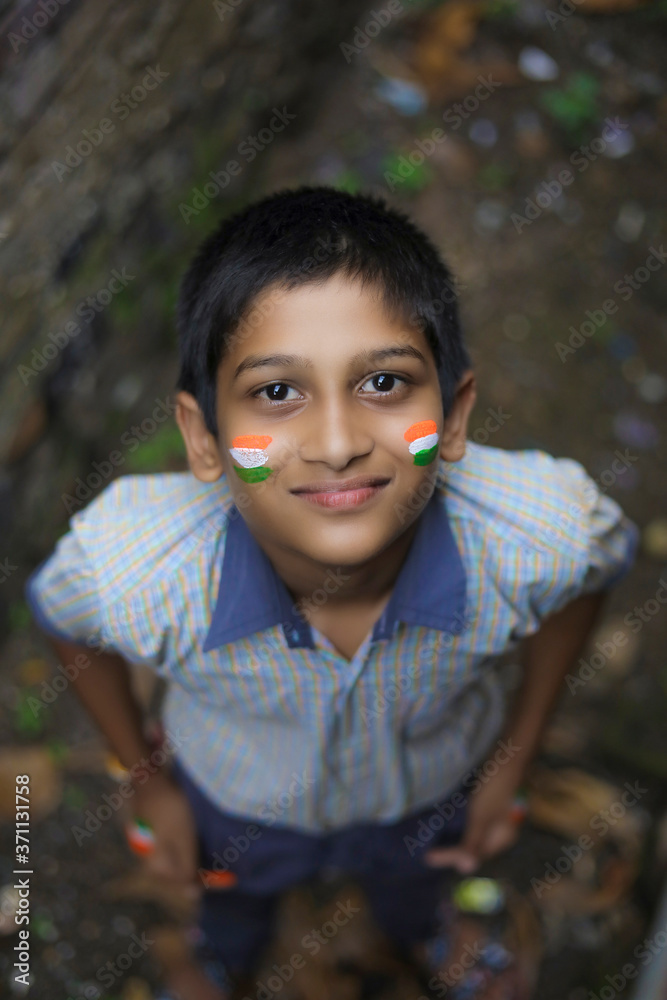 young indian child with indian flag on face Stock Photo | Adobe Stock