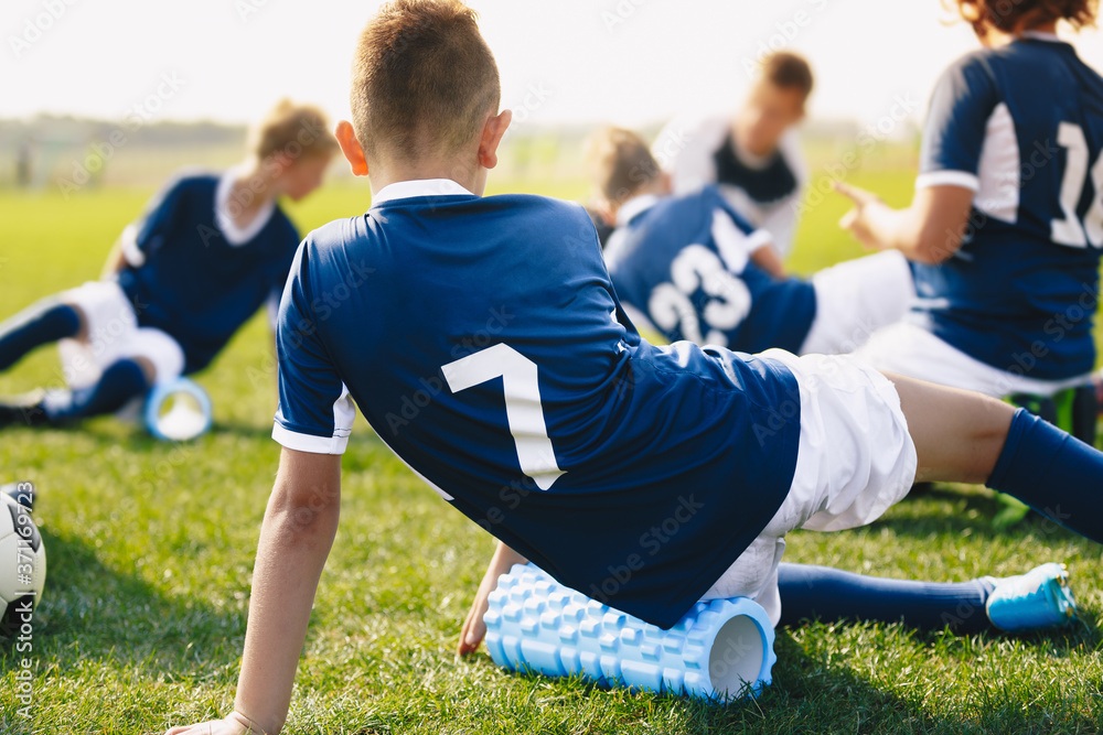 School Soccer Stretching Session. Young Footballers Using Foam Rollers ...