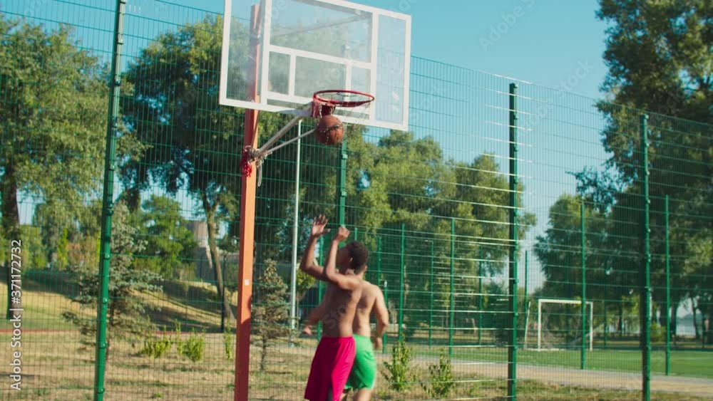 Shirtless athletic african american streetball player driving to the ...